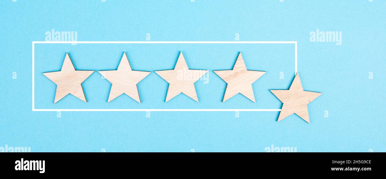 Five stars on a blue colored background, hand put the last star in the ...