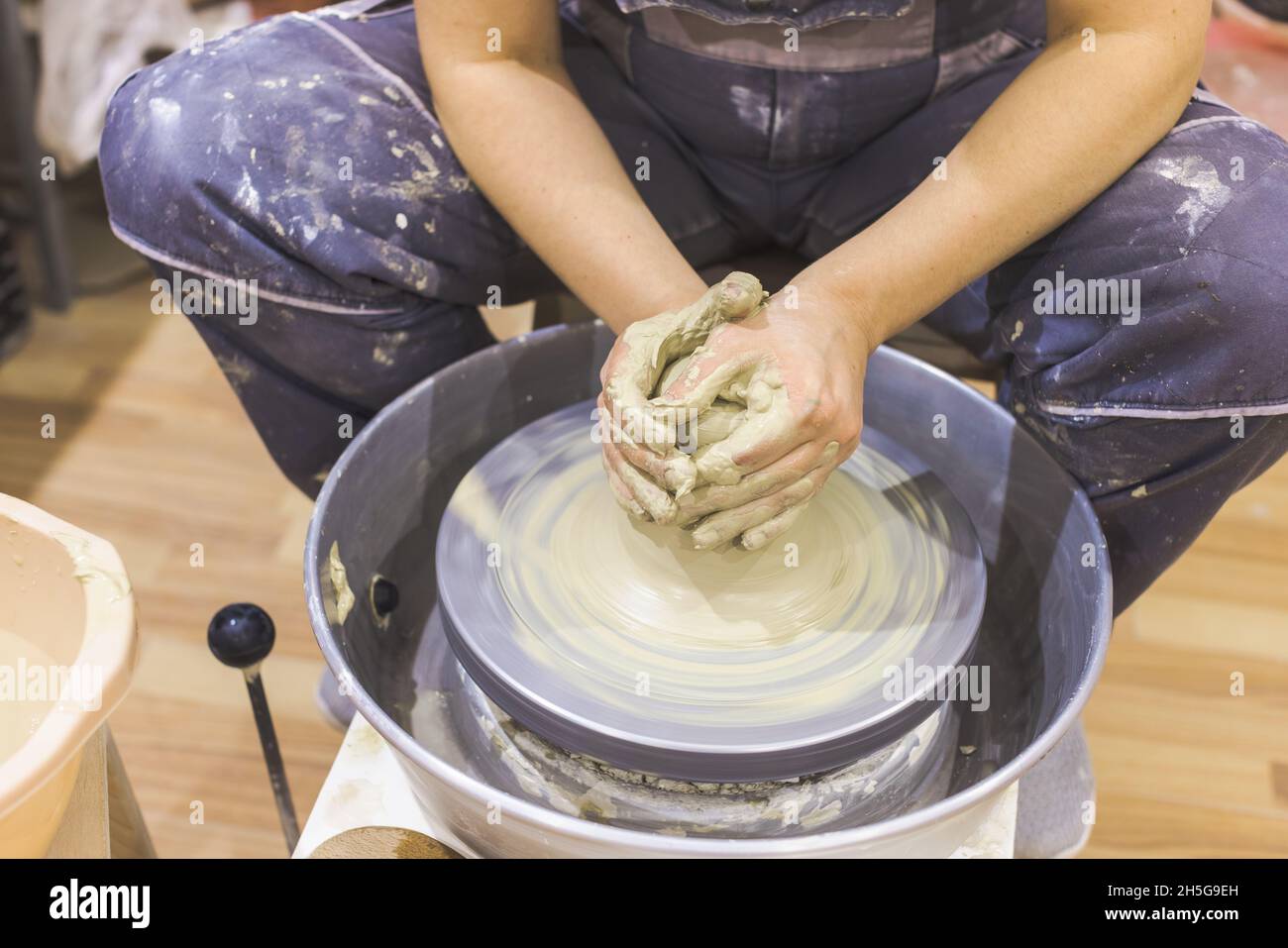 Ceramic Artist hands mold clay on pottery wheel. Creative workshop ...