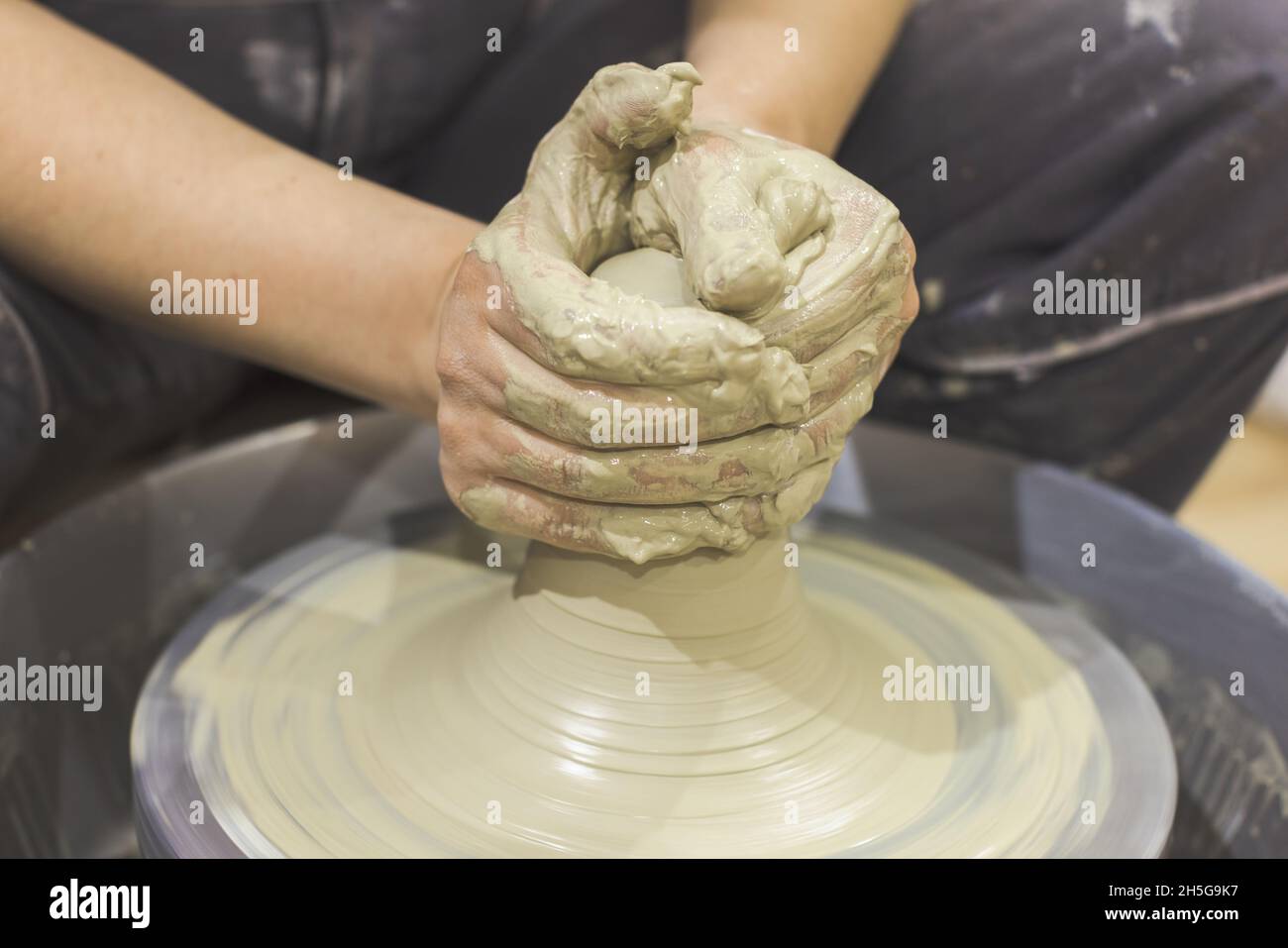 Ceramic Artist hands mold clay on pottery wheel. Creative workshop ...