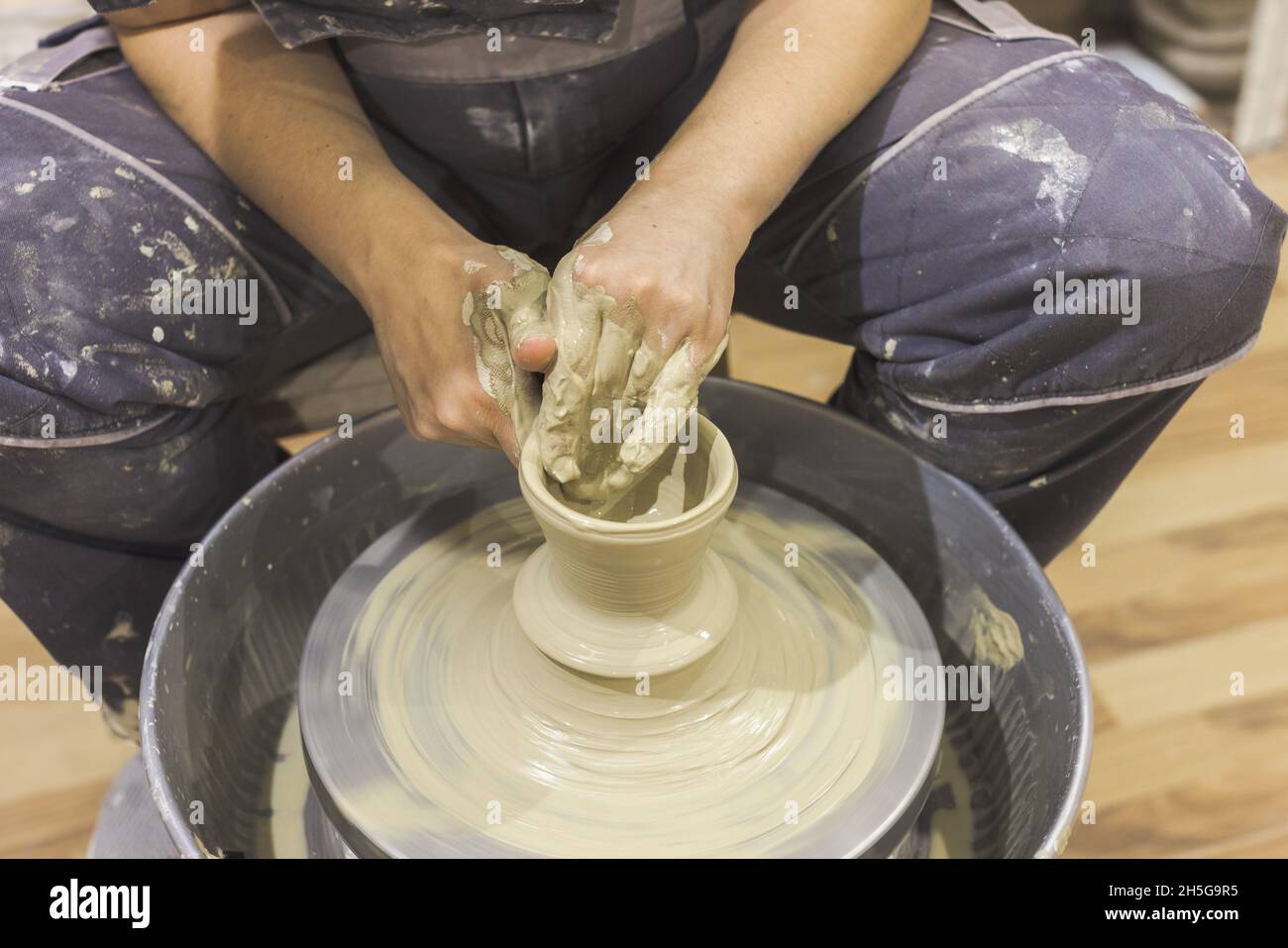 Ceramic Artist hands mold clay on pottery wheel. Creative workshop ...