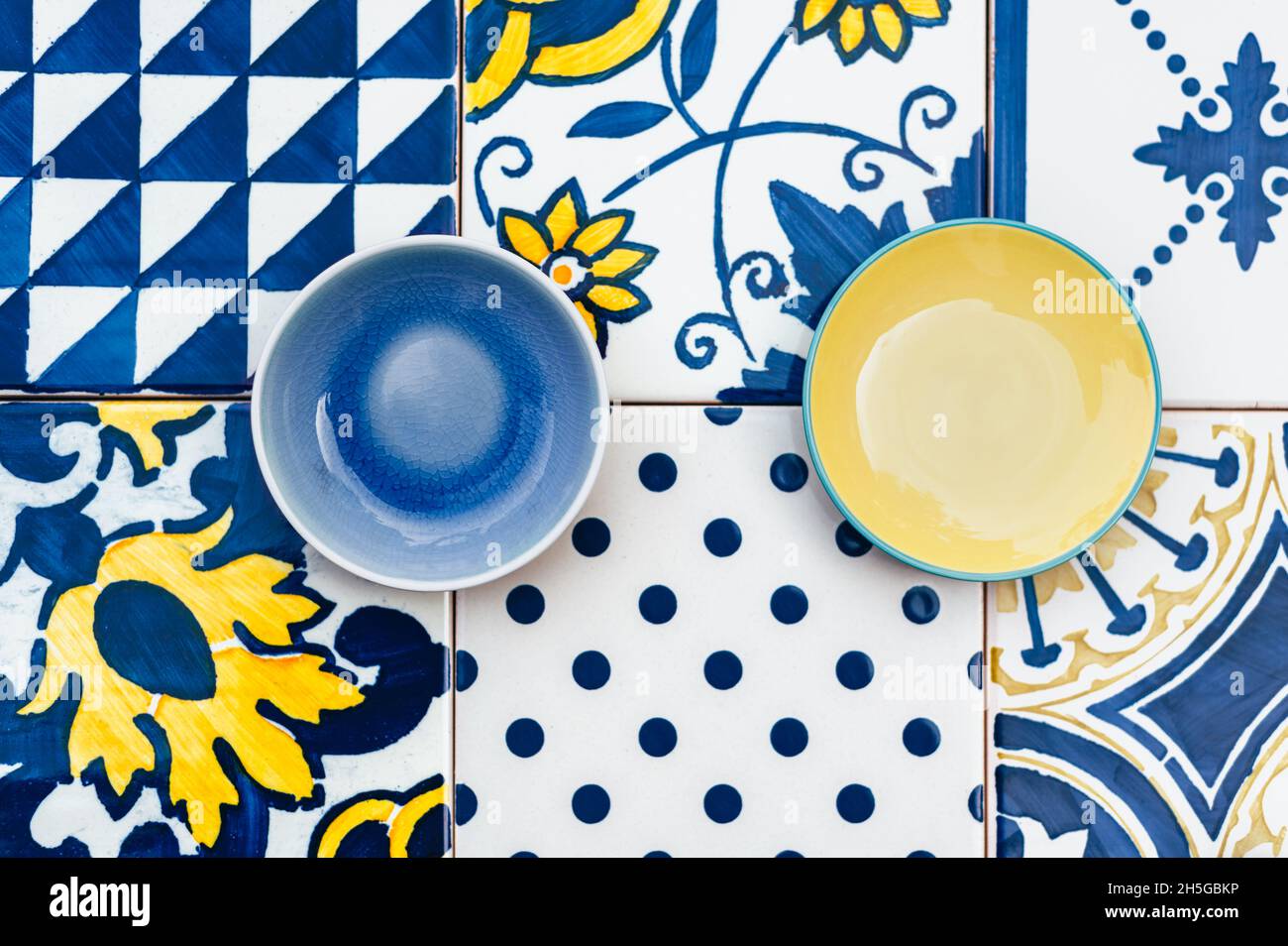 Plates on tile background Stock Photo - Alamy