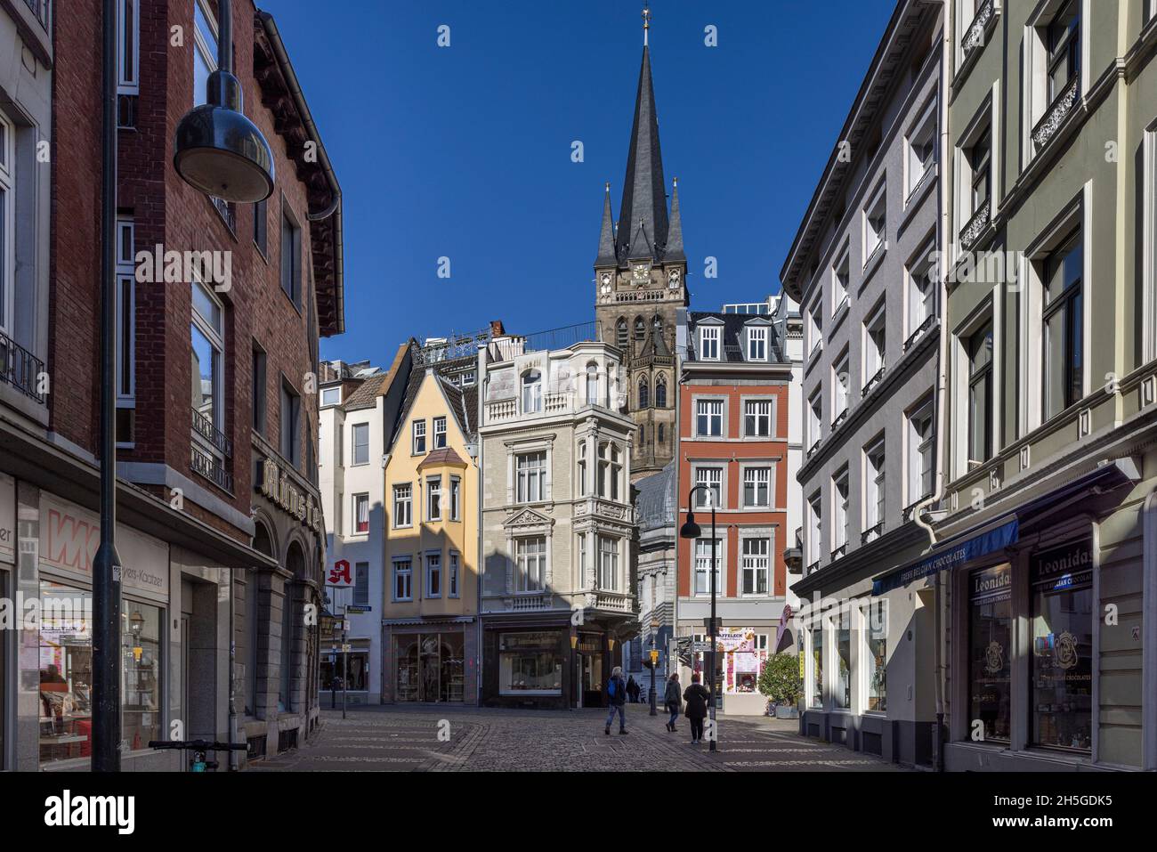Narrow streets in Aachen old town with incidental people walking by ...