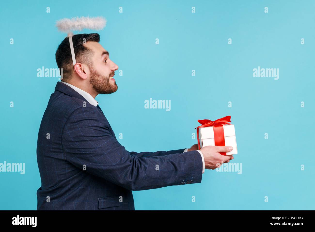 Side view of handsome bearded male wearing official style suit, halo ...