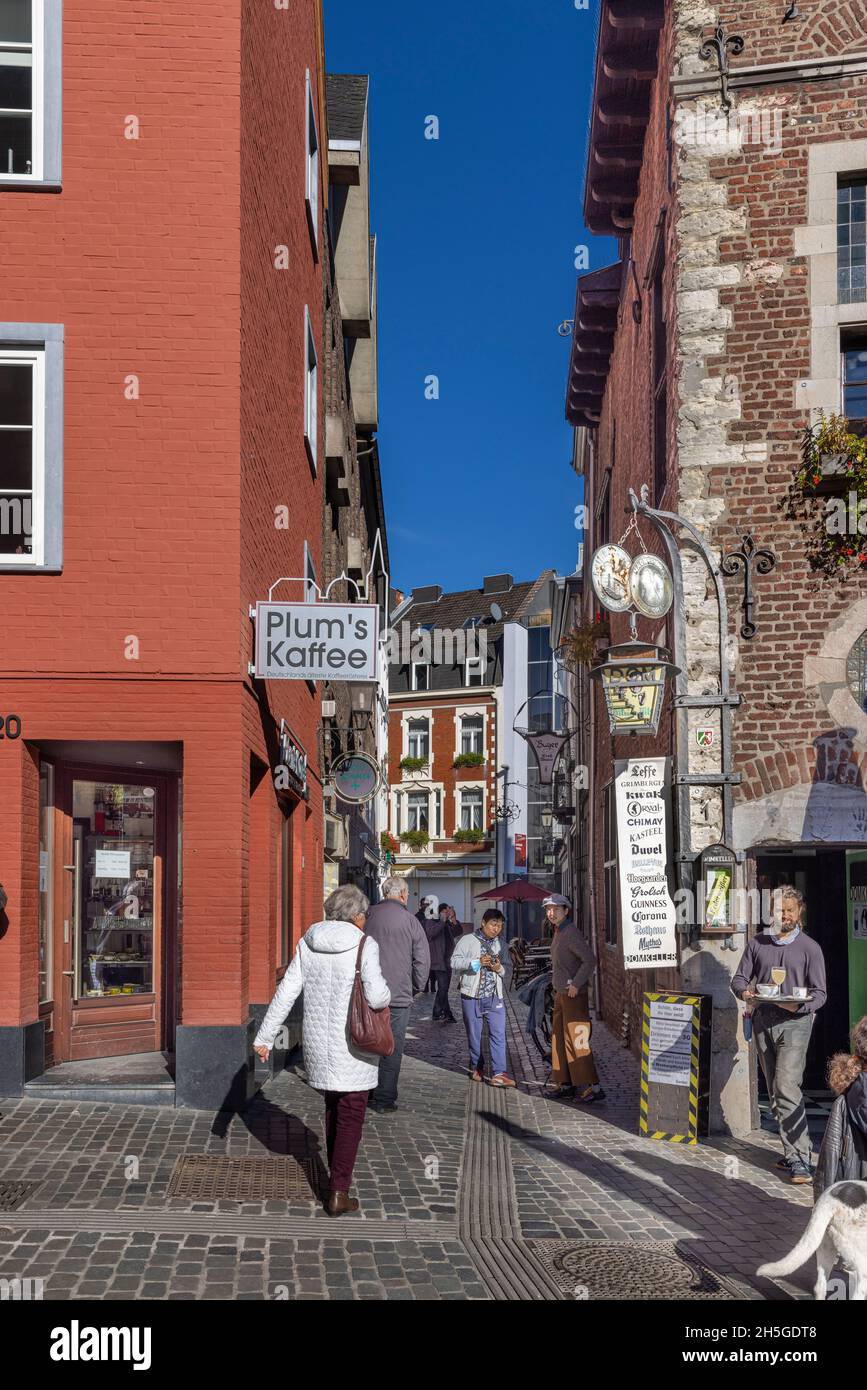 Narrow streets in Aachen old town with incidental people walking by ...