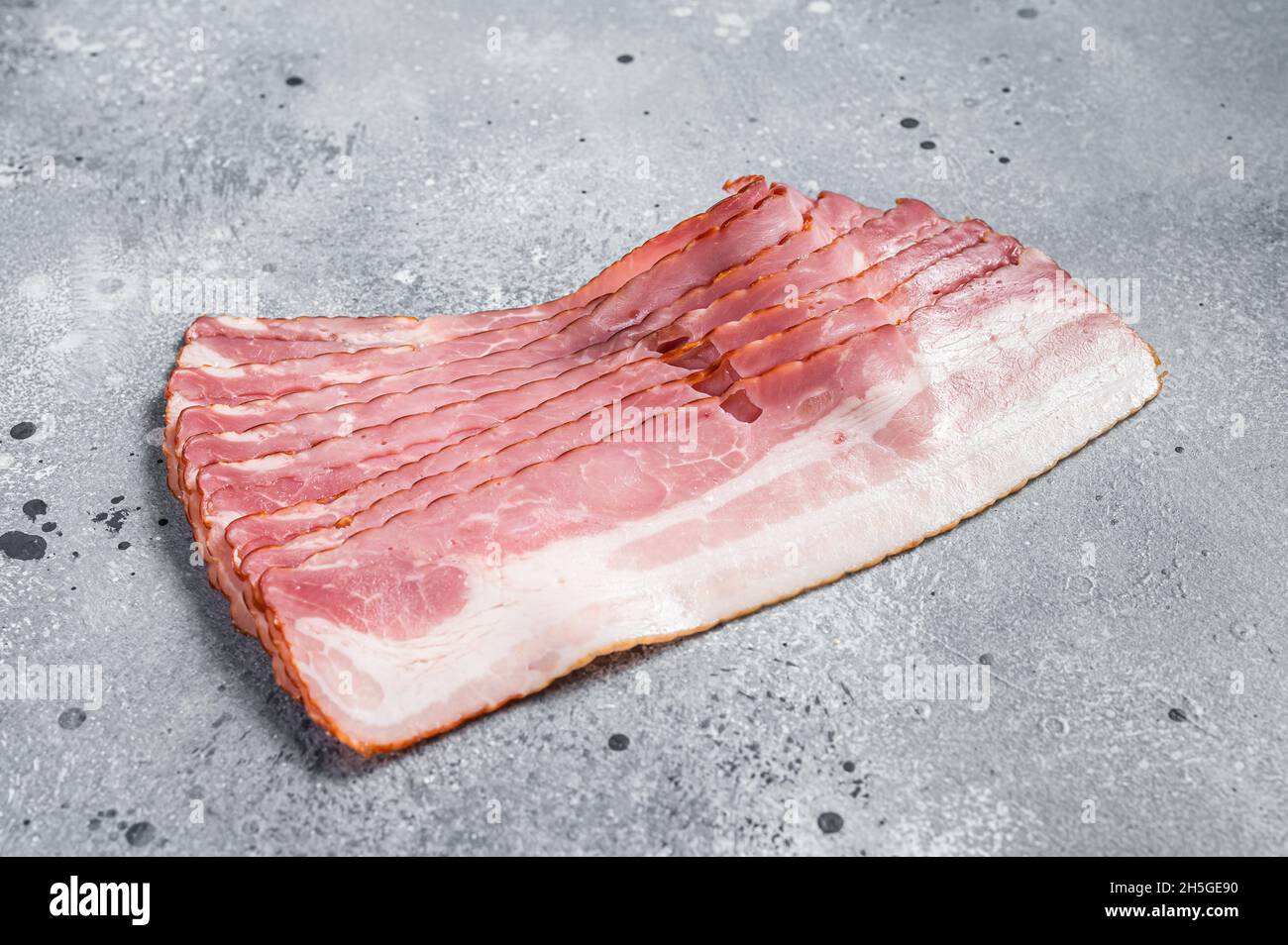 Raw bacon strips of pork meat. Gray background. Top view Stock Photo ...
