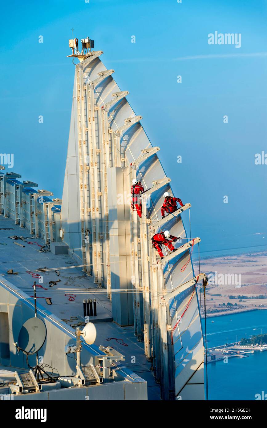 Window washers at work in the Persian Gulf, in Abu Dhabi City, UAE; Abu ...