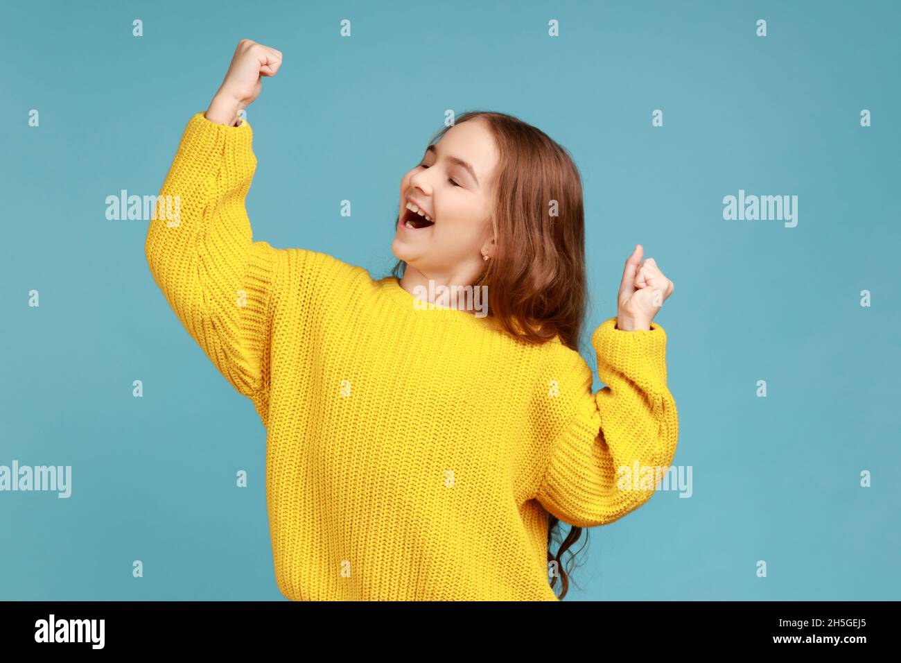 Little girl shouting from happiness, showing yes gesture with raised ...