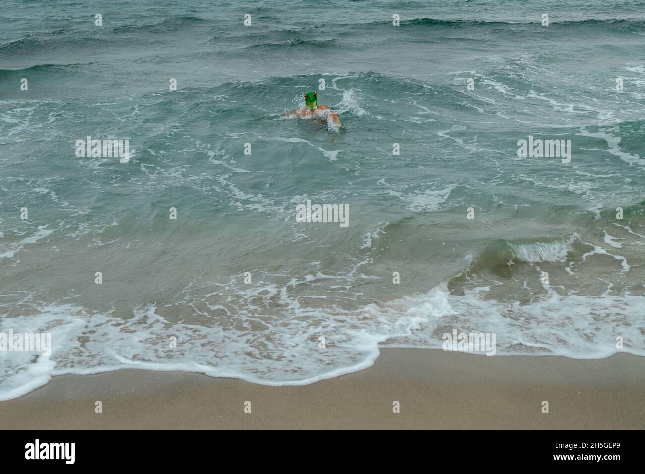 Aerial view of a Caucasian male with a frog head in the sea Stock Photo ...
