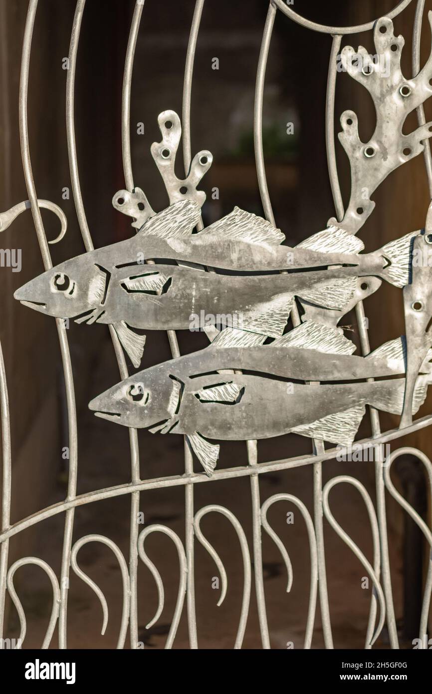 Ornate and decorative metal gate with a fish design covering the ...