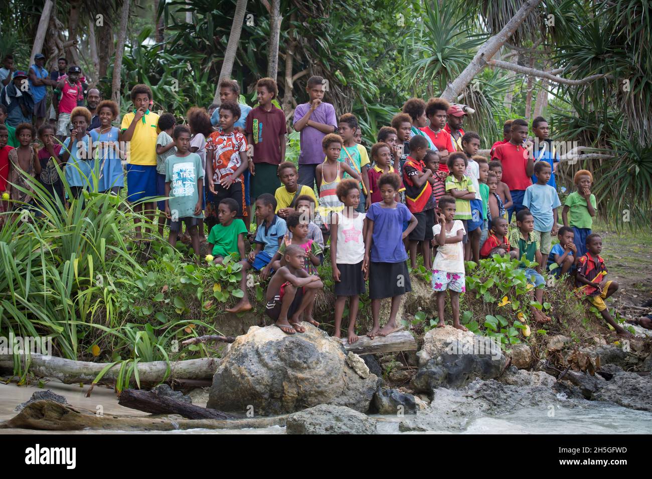 Children gathered on the shore of Tuam Island of the Siassi, Papua New ...