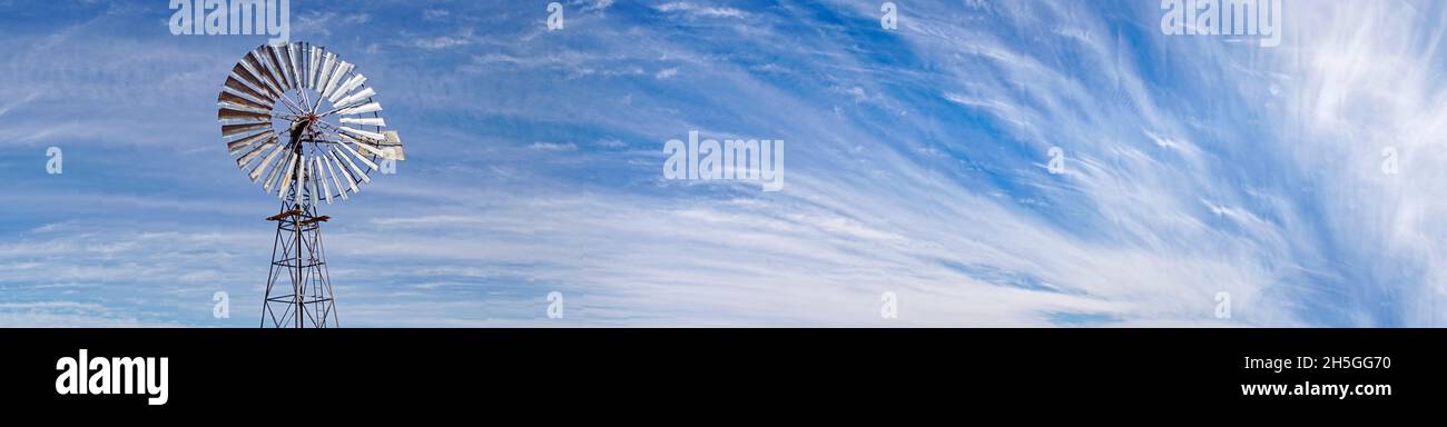 panorama photo of clouds with a windmill on one side of photo Stock ...