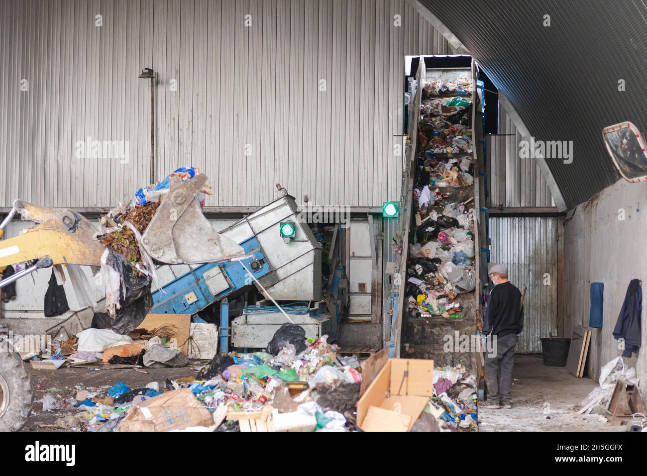 Loading garbage onto the tape. Sorting of garbage immediately after ...