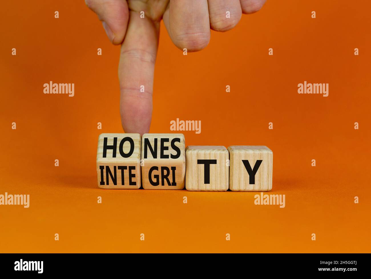 Honesty and integrity symbol. Businessman turns wooden cubes and ...