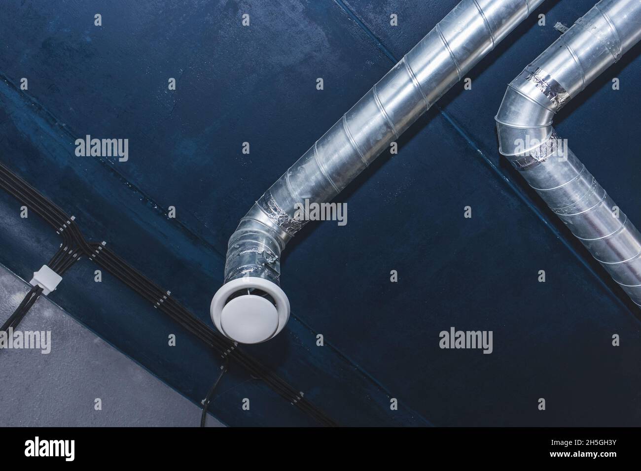 Ventilation pipe system at the ceiling of an industrial enterprise or ...