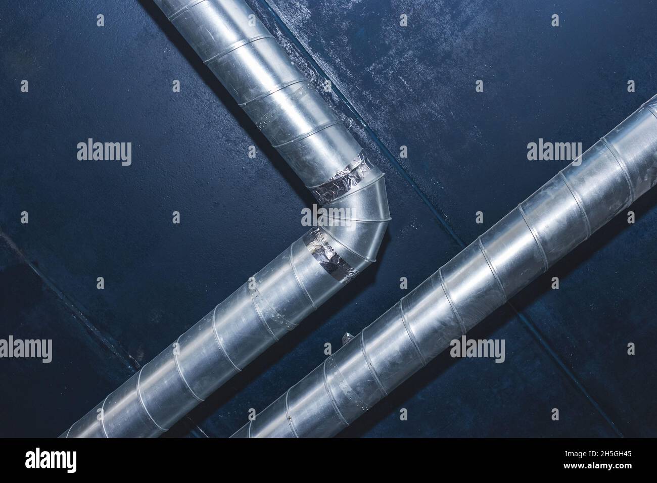 Ventilation pipe system at the ceiling of an industrial enterprise or ...