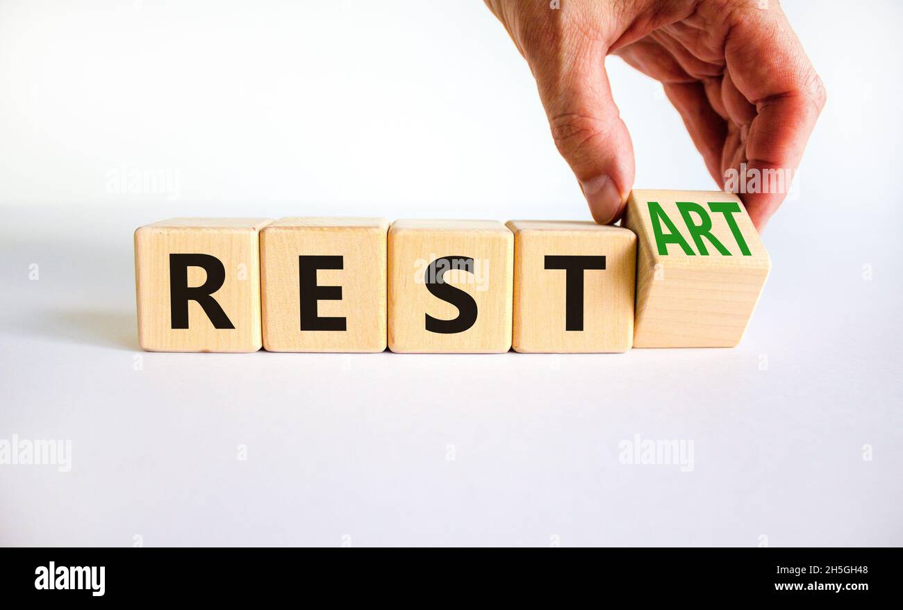 Rest and restart symbol. Businessman turns a wooden cube and changes ...
