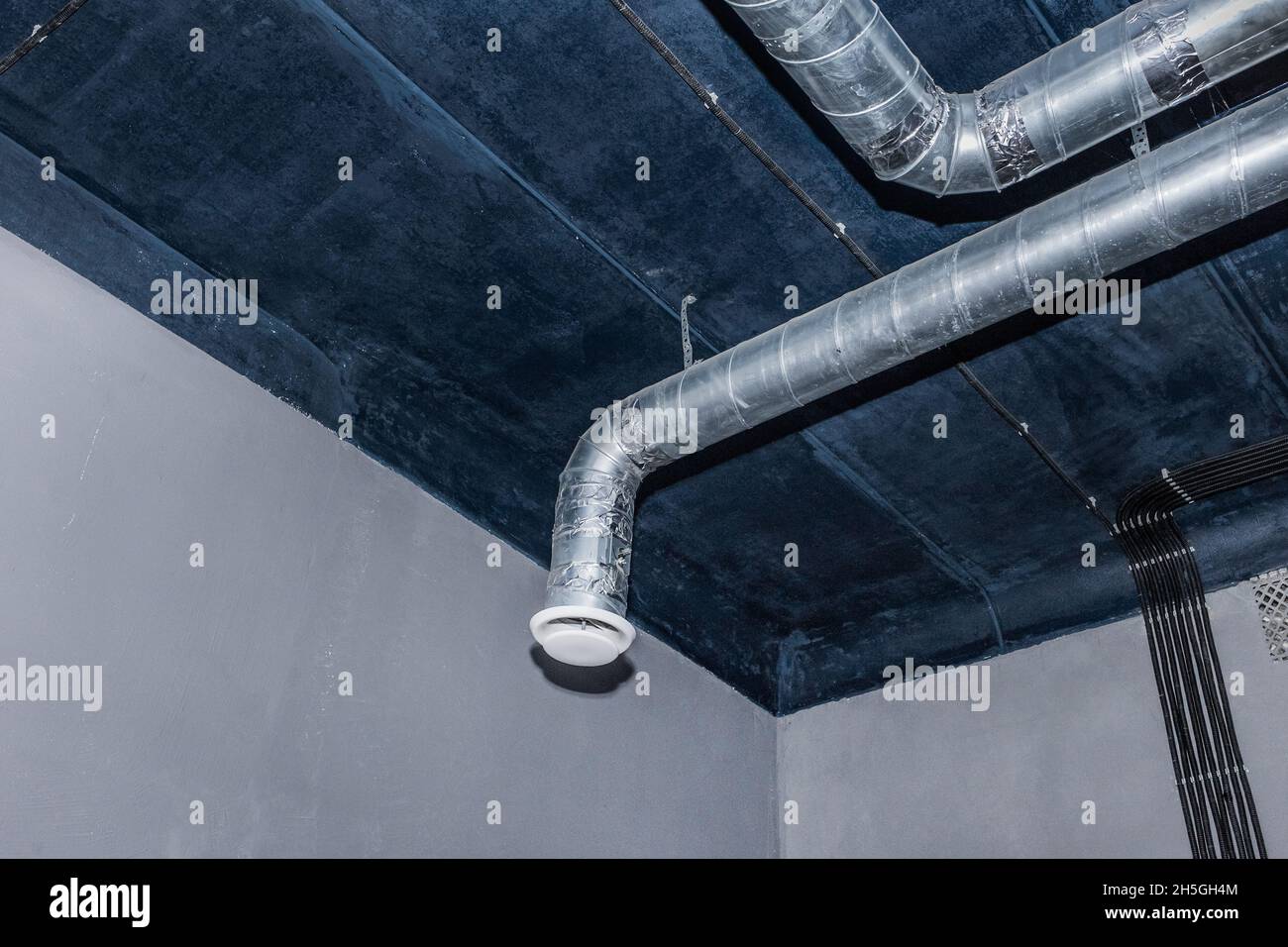 Ventilation pipe system at the ceiling of an industrial enterprise or ...