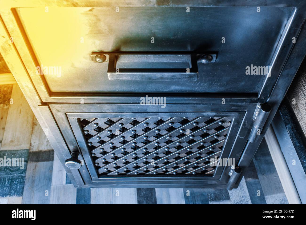 A person's hand opens the handle of an iron cabinet or drawer Stock ...