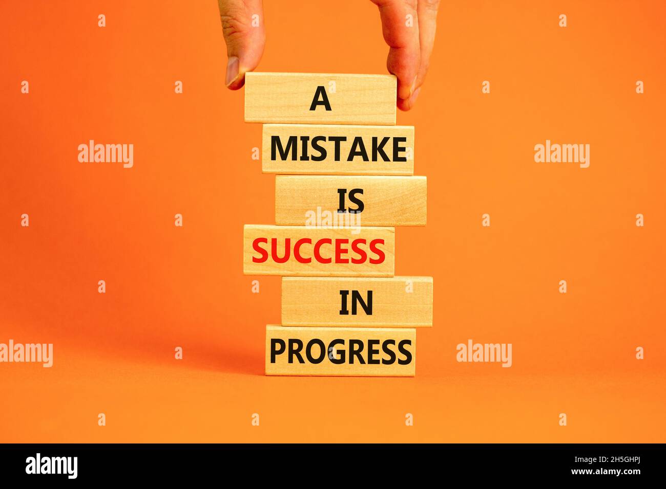 Mistake or success symbol. Wooden blocks with words A mistake is ...