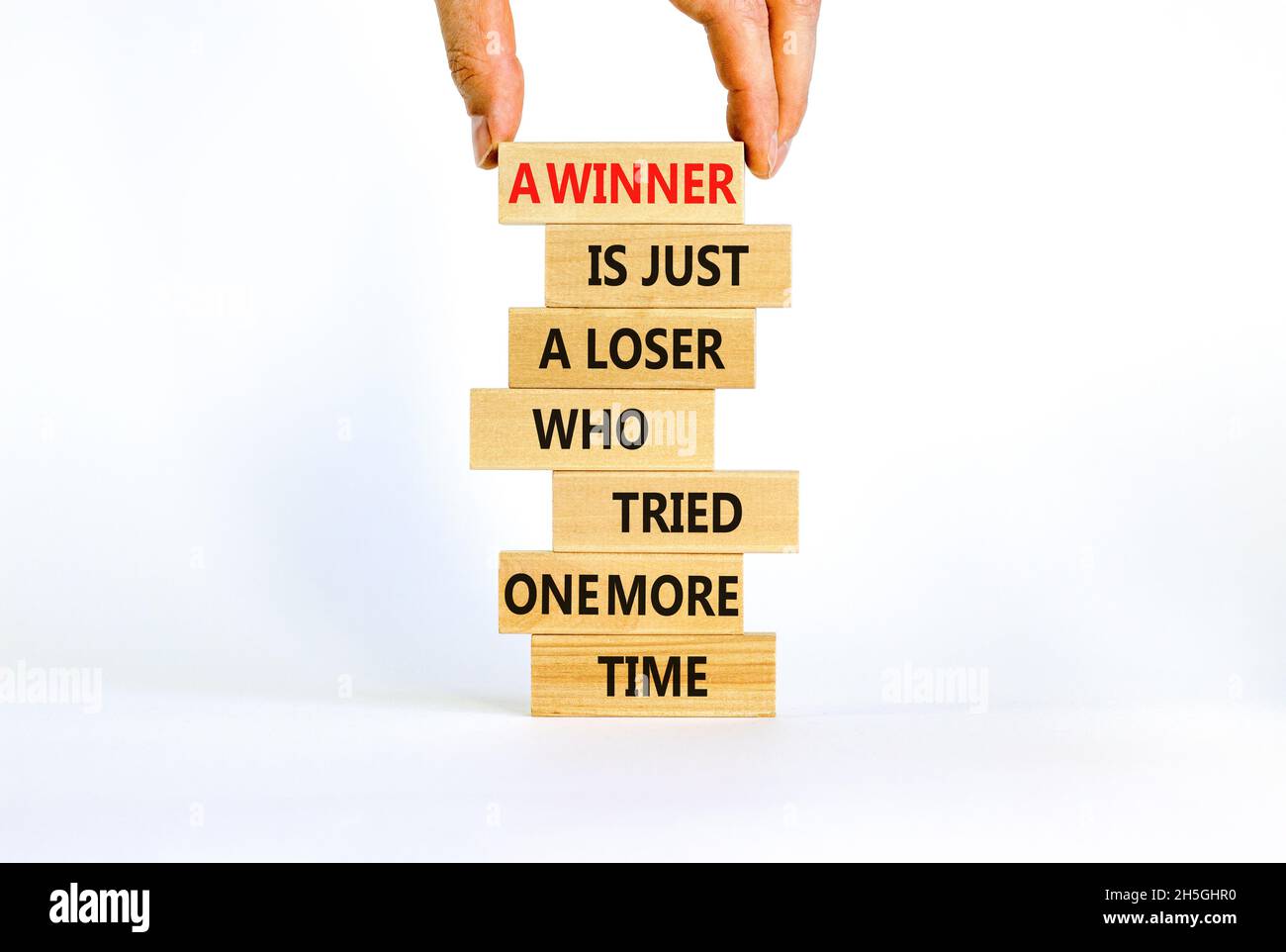 Winner or loser symbol. Wooden blocks with words A winner is just a ... Winner or loser symbol. Wooden blocks with words A winner is just a ...