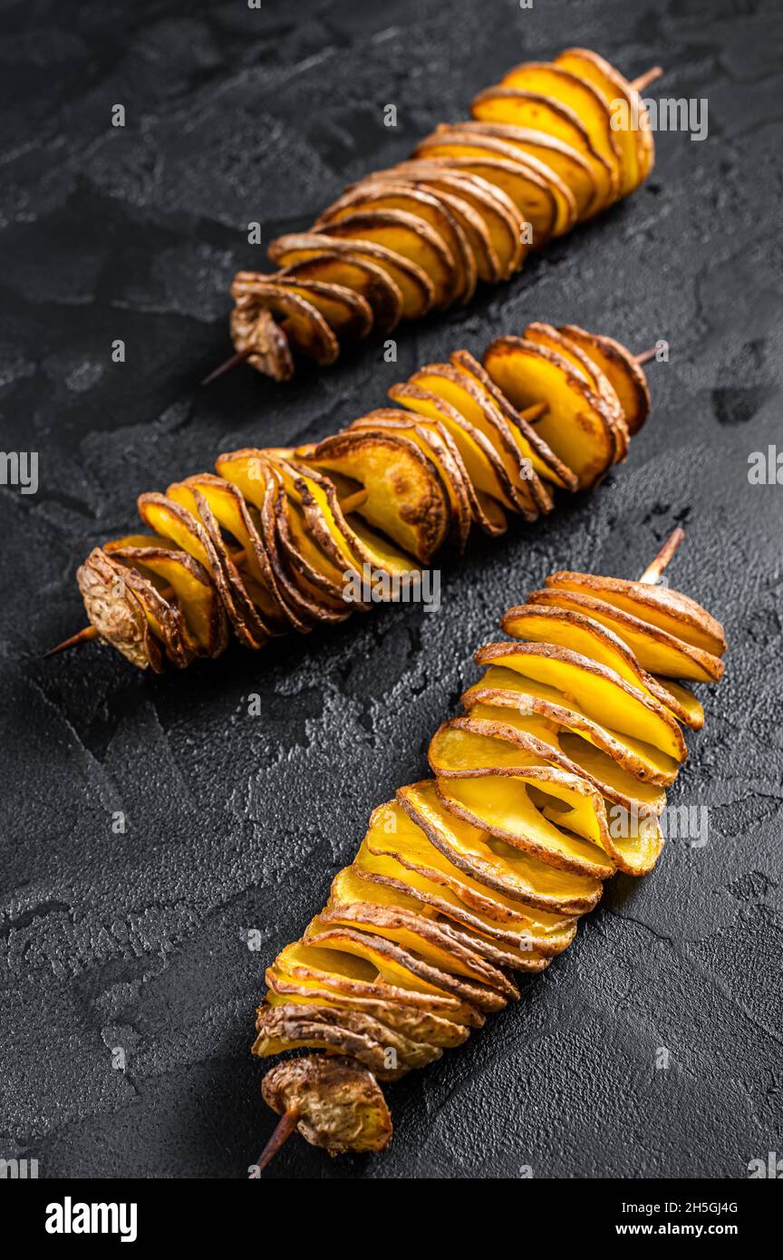 Twisted tornado potatoes chips. Black background. Top view Stock Photo ...