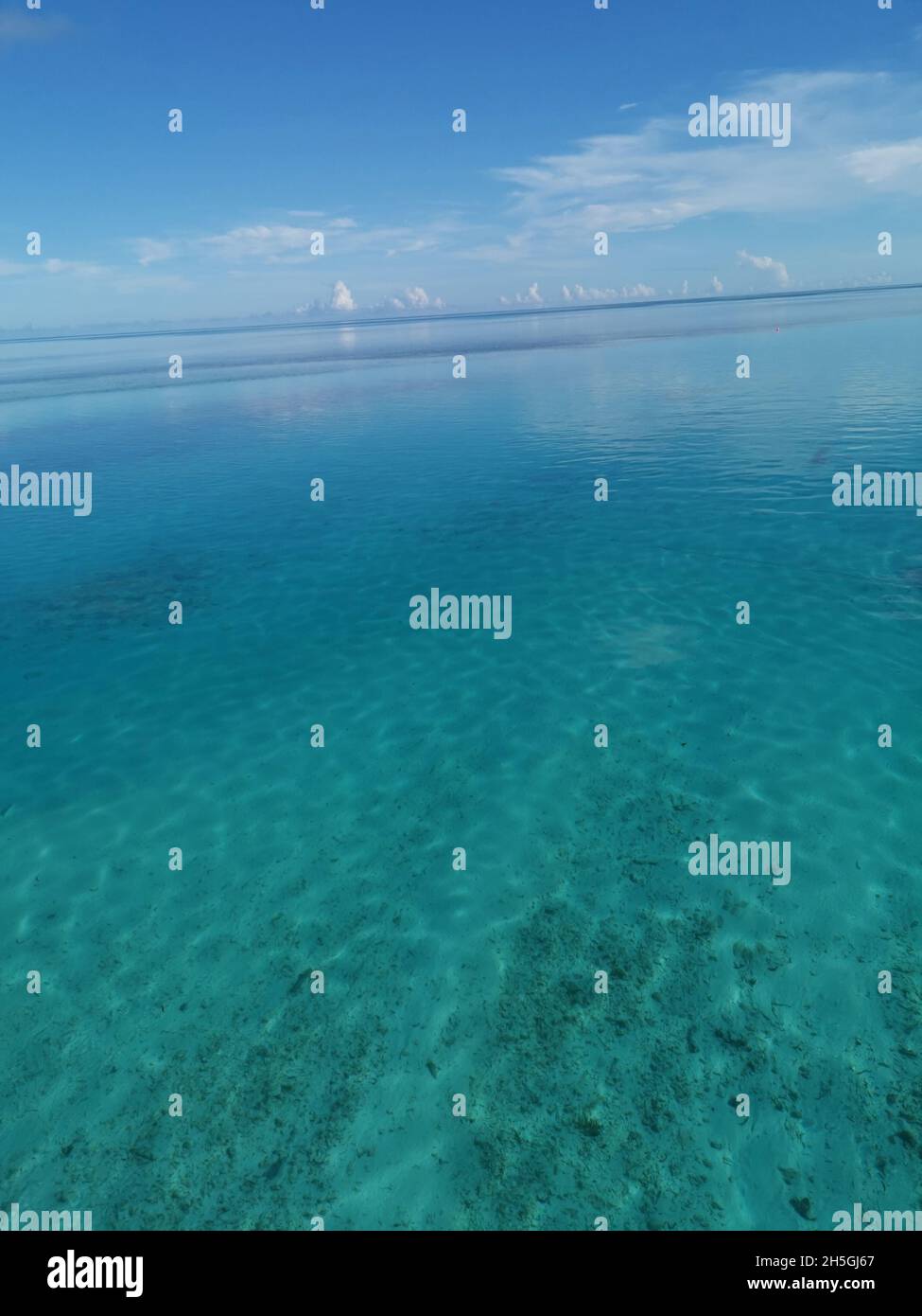 Vertical shot of ripples on a bright blue green sea surface Stock Photo ...