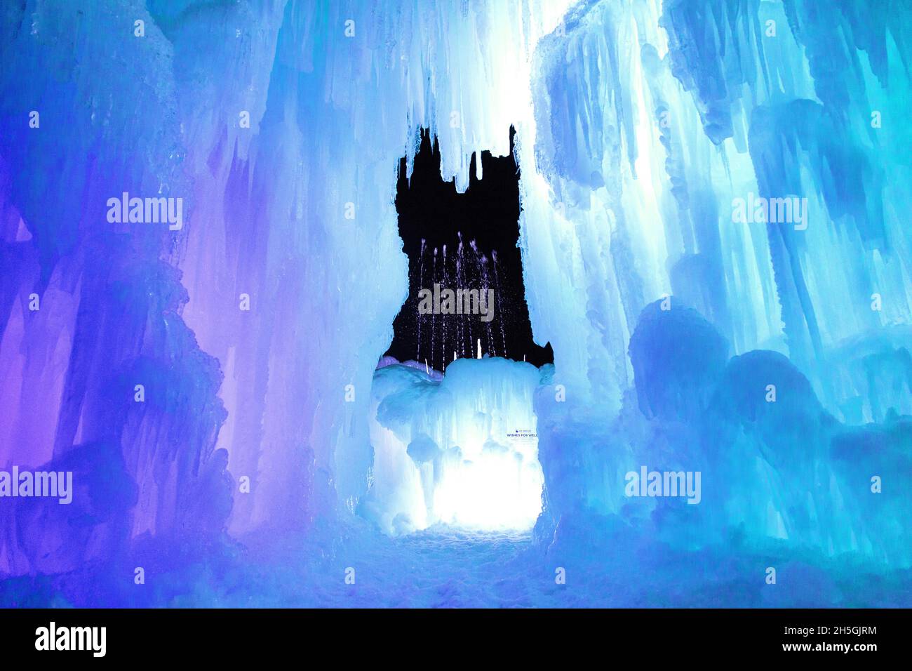 Beautiful view of an ice cave with colorful lights Stock Photo - Alamy