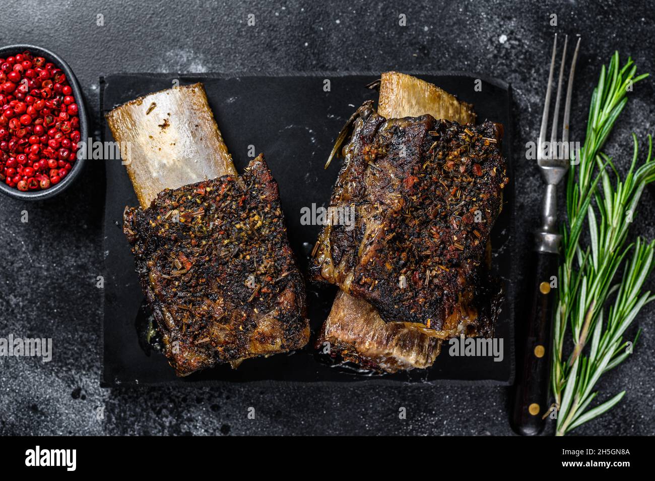 BBQ Beef Short Ribs with herbs. Black background. Top view Stock Photo ...