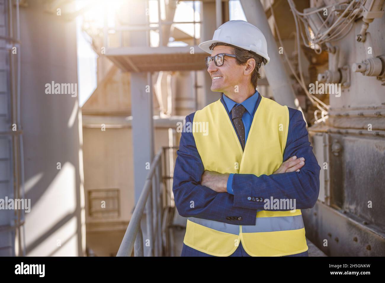 Cheerful male engineer standing at manufacturing plant Stock Photo - Alamy