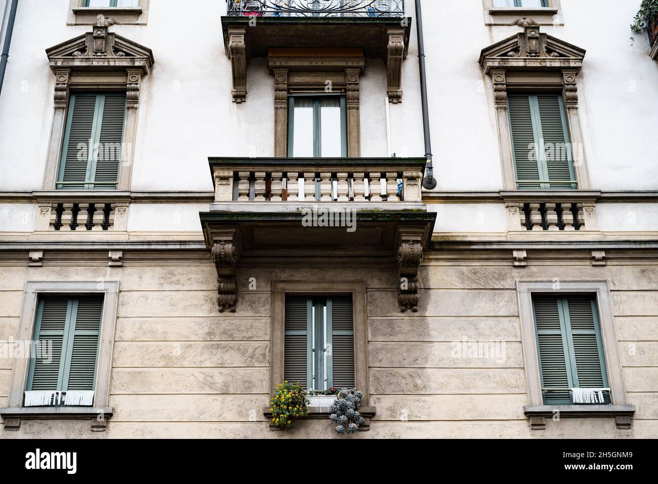 Carved stone balconies with balusters on the facade of the building ...