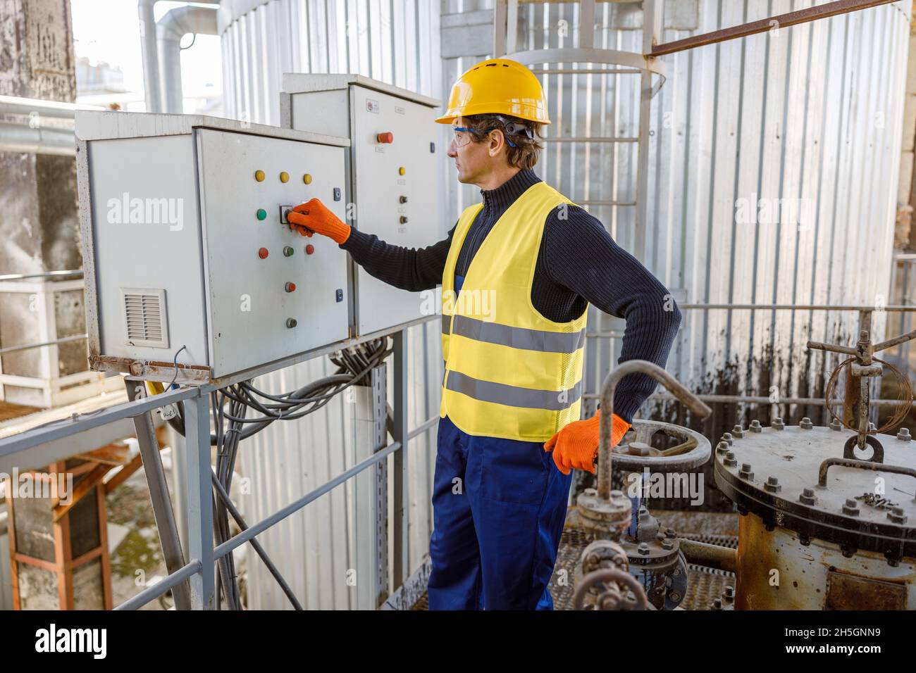 Male worker using control box at factory Stock Photo - Alamy