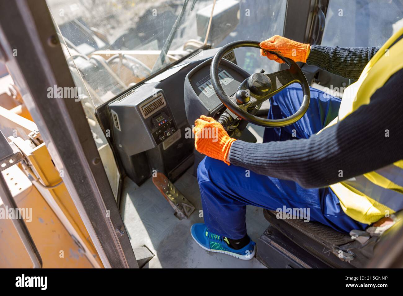 Male worker driving industrial vehicle at factory Stock Photo - Alamy