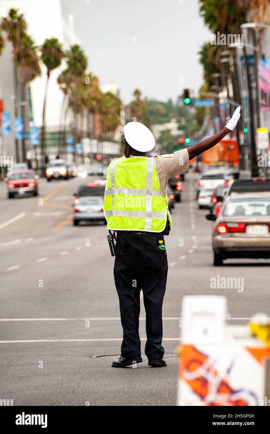 Traffic police officer gives direction in a busy intersection Stock ...