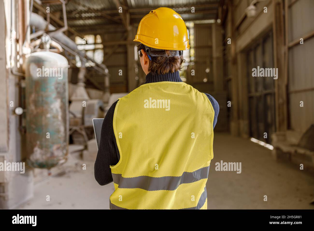 Man engineer standing in warehouse at factory Stock Photo - Alamy