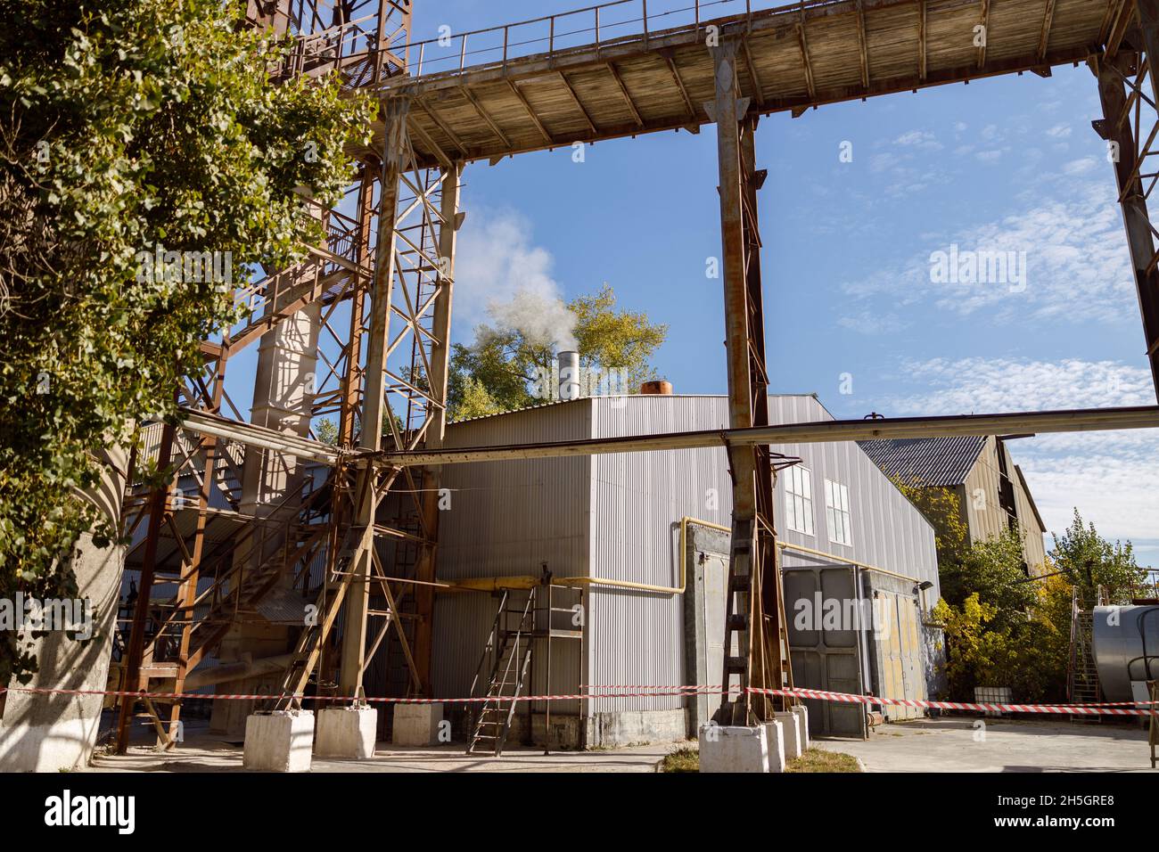 Factory with warehouse and industrial crane system outdoors Stock Photo ...