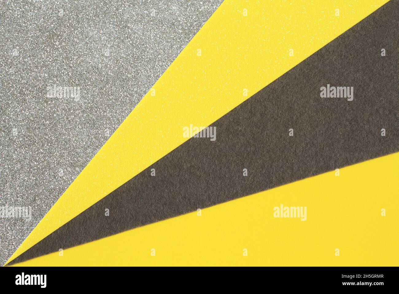 Gray and yellow foamiran sheets folded on a white sheet of Whatman ...