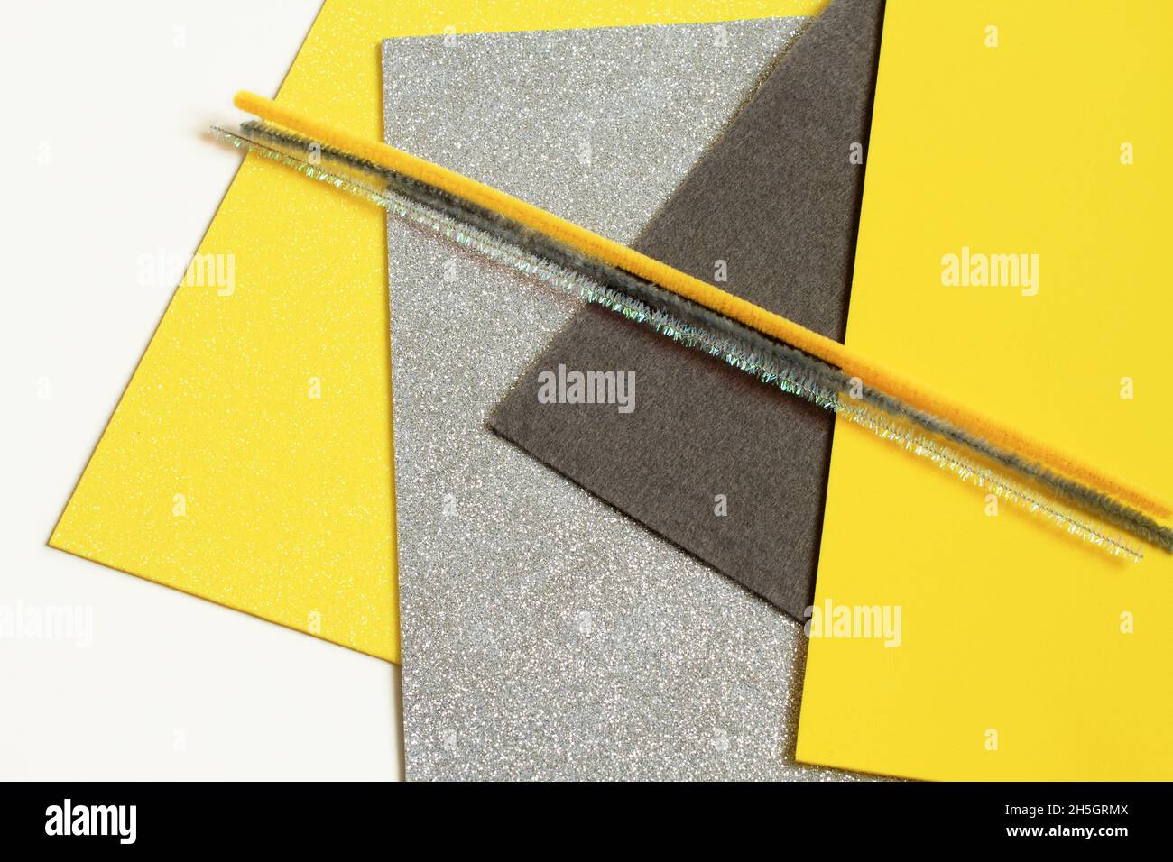 Gray, silver and yellow foamiran sheets together with fluffy decorative ...