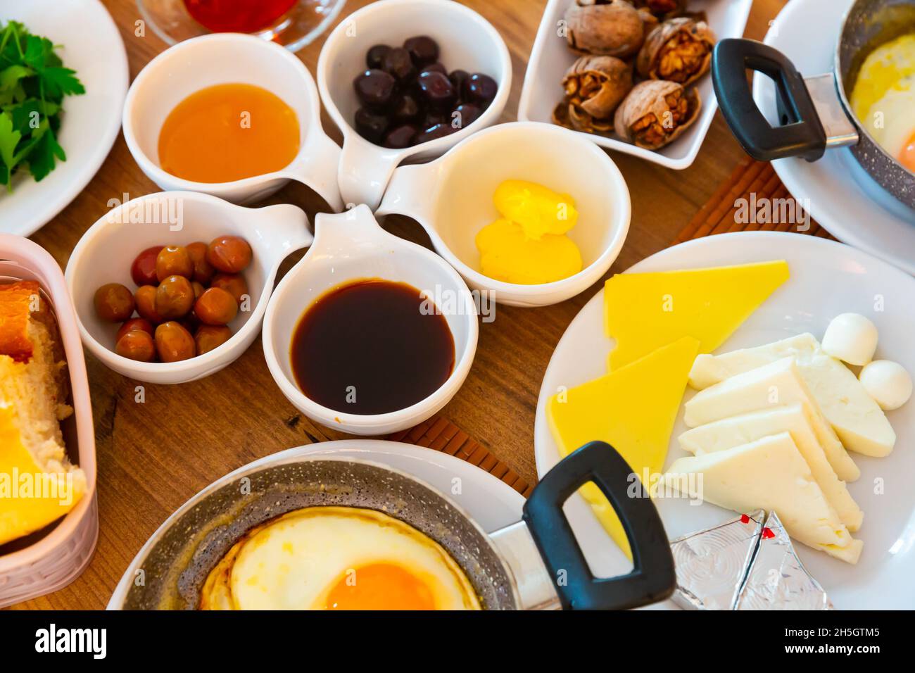 Turkish breakfast: egg, vegetables, cheeses, olives and ham. Halal ...