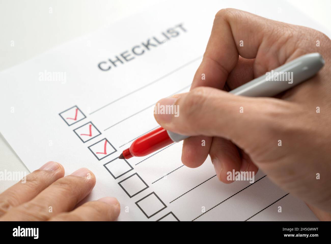 Hand with red marker pen marking on checklist box Stock Photo - Alamy