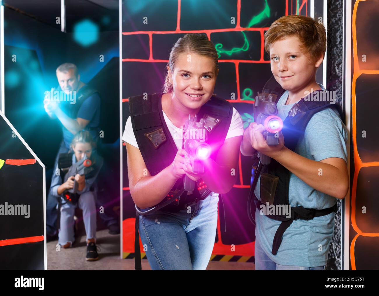 Cheerful boy and his mother aiming laser guns Stock Photo - Alamy