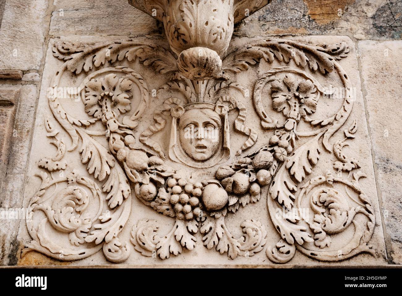 Woman face with floral patterns on the stone slab of the Duomo facade ...