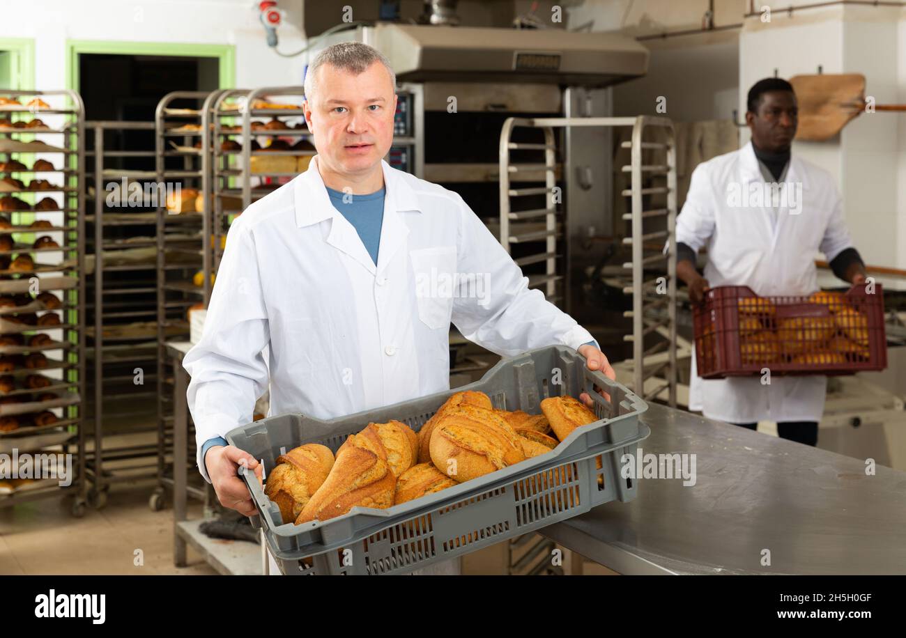 Successful baker during daily work in bakeshop Stock Photo - Alamy