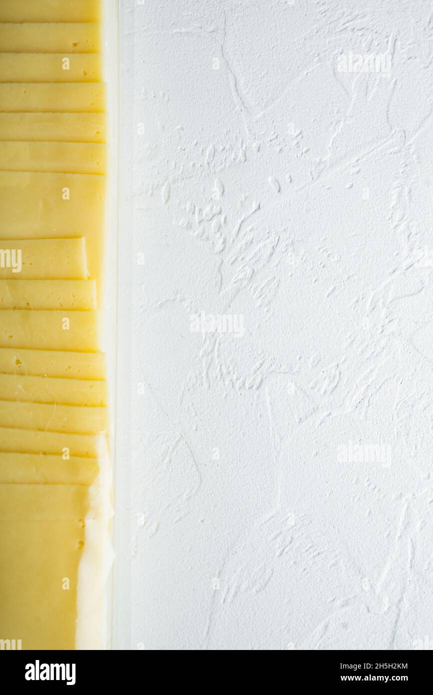 Slices of american cheese plastic pack, on white background with copy ...