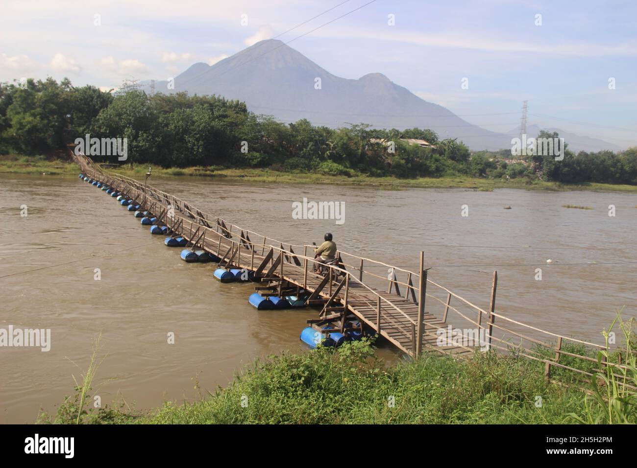 SIDOARJO, INDONESIA - NOVEMBER 06, 2021: The floating bridge (Sutam Bridge) is above the Brantas ...