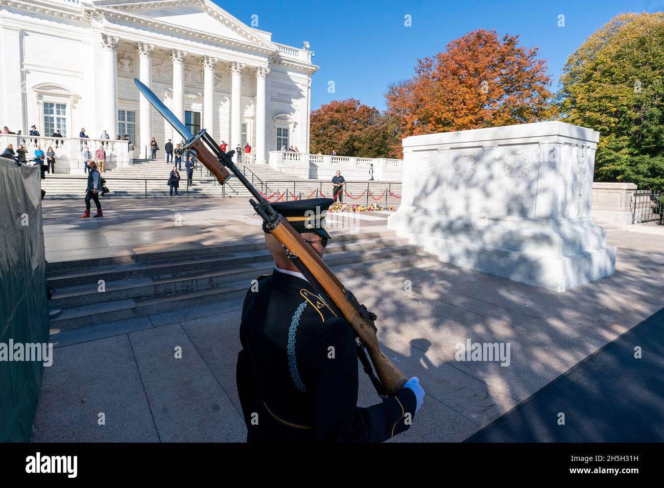People place flowers as a tomb guard of the 3rd U.S. Infantry Regiment ...