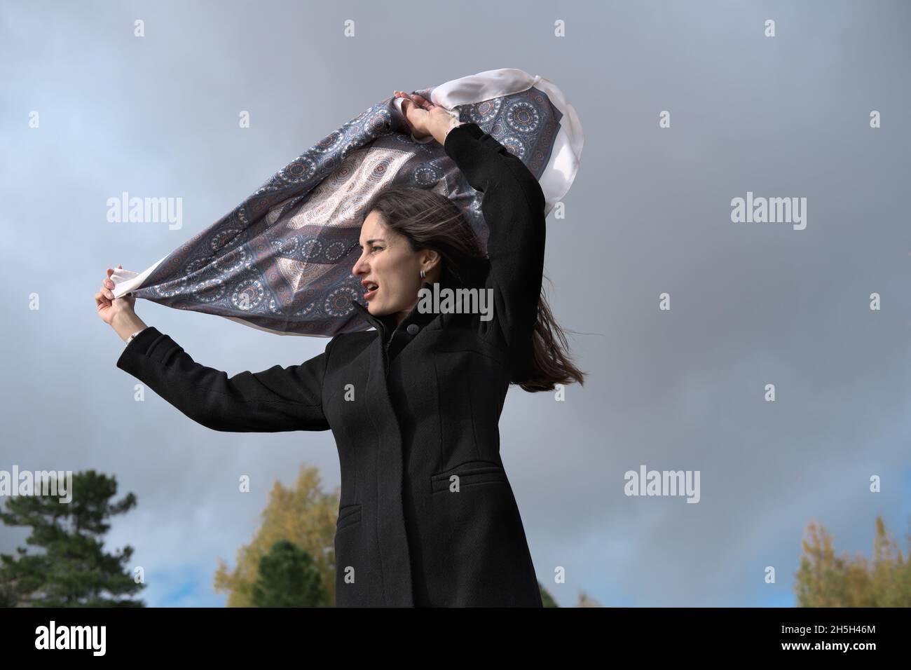 woman holding a neckerchief over a head, shouting emotionally. woman ...