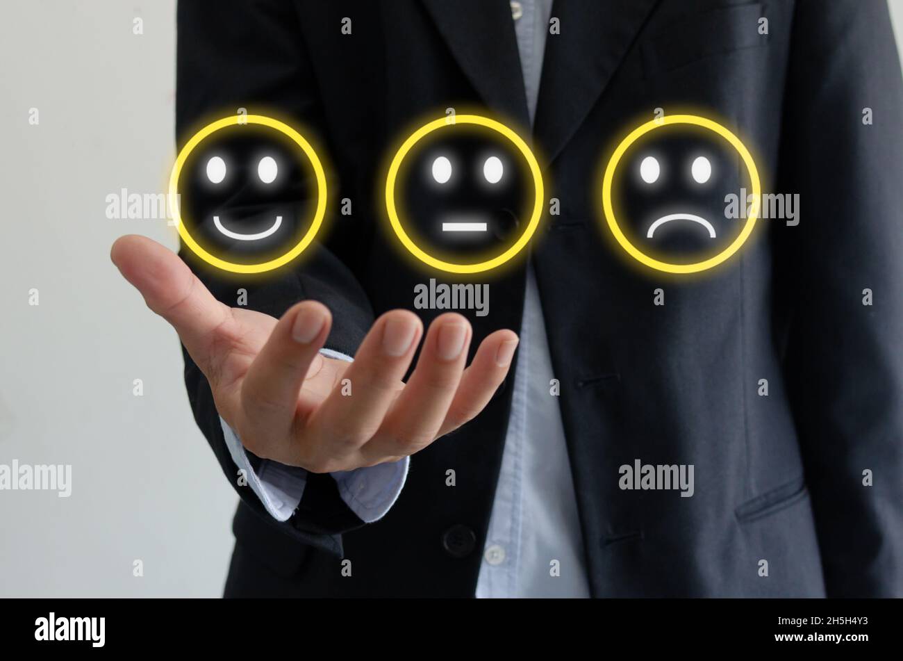 male hand with an emoticon.Customer ratings and service satisfaction ...