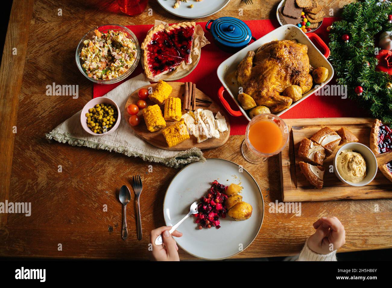 Close-up top view of unrecognizable person sitting at dinner feast ...