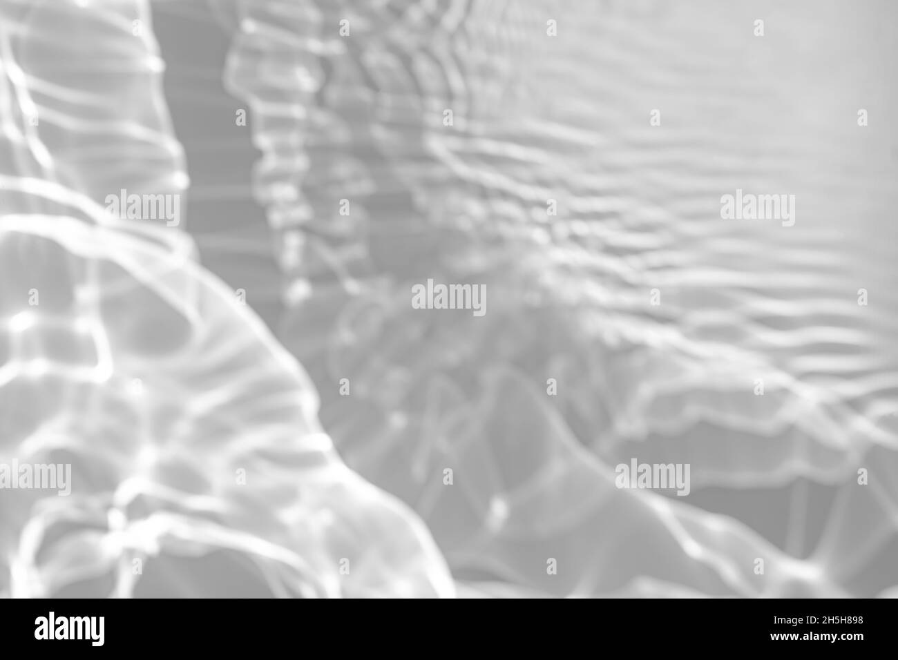 blurred shadow and light caustic effect on a white wall Stock Photo - Alamy