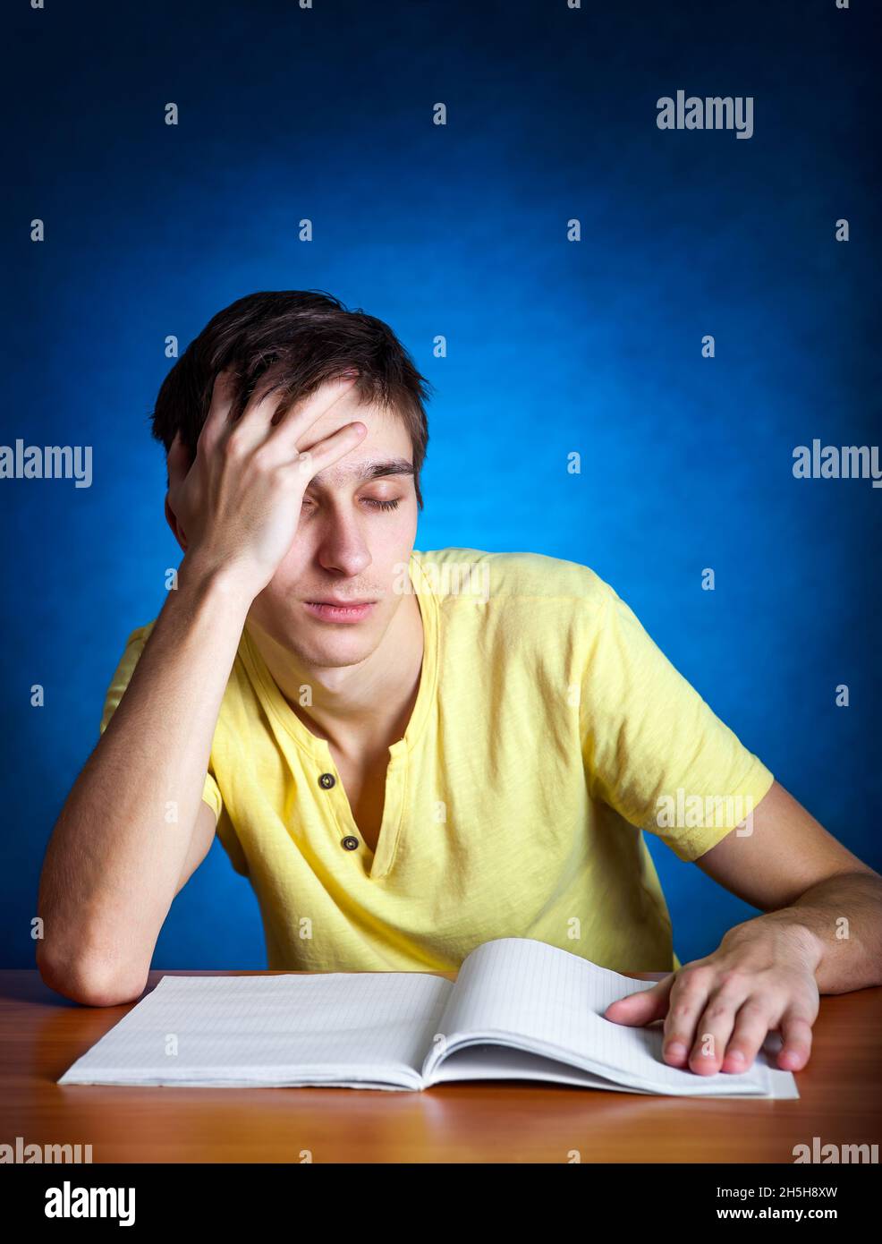 Sad and Tired Student on the Blue Background Stock Photo - Alamy